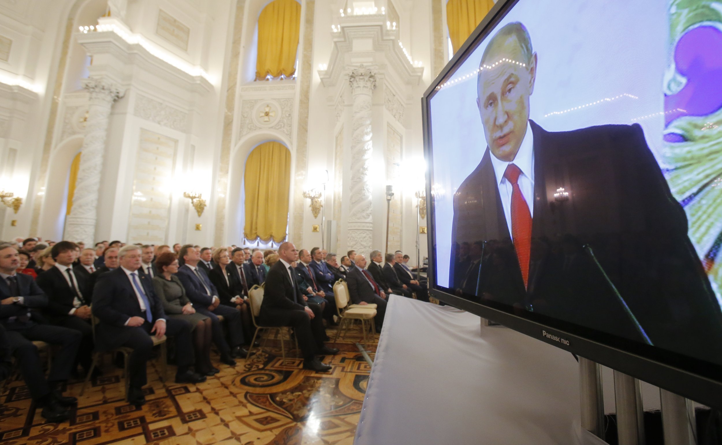 Russian Official Listens To Putins Speech With Noodles On Ears